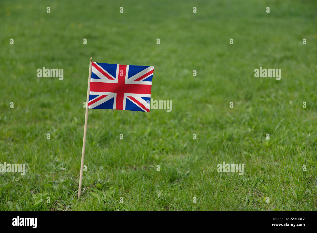 UK flag, United Kingdom/ Great Britain flag on a green grass lawn field ...