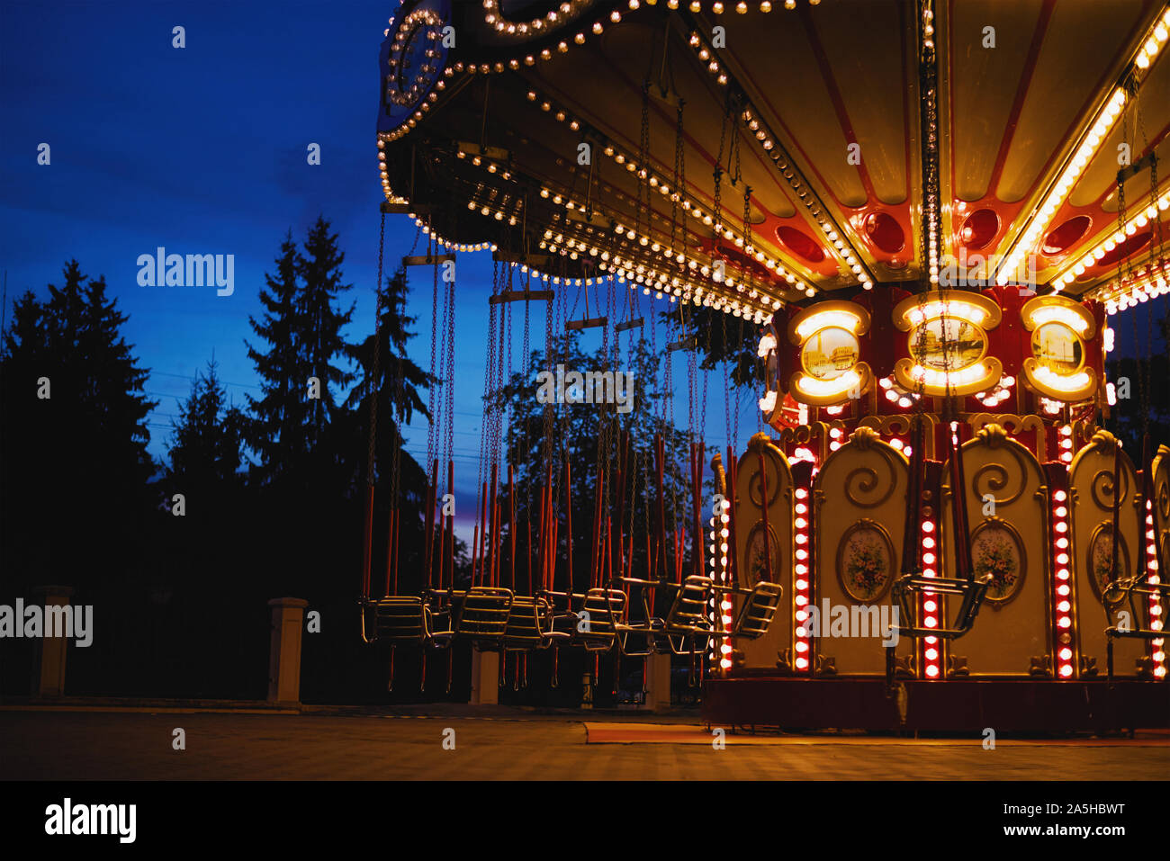 Carousel Merry-go-round in amusement park at night city Stock Photo - Alamy
