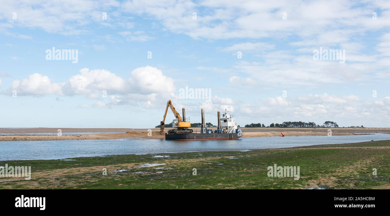 Barge mounted dredger digging out a coastal channel Stock Photo - Alamy