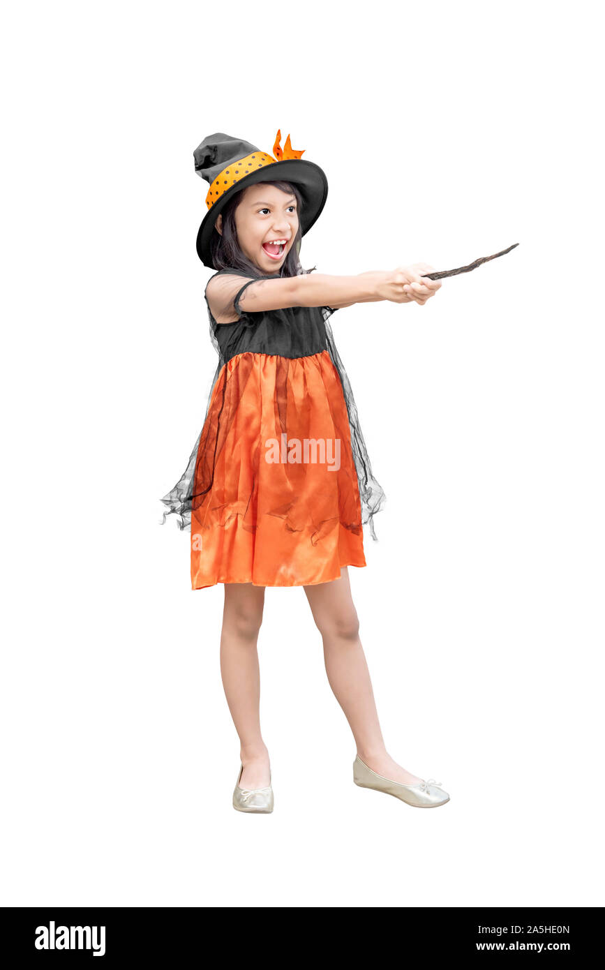 Asian girl in witch costume holding a magic wand isolated over white ...