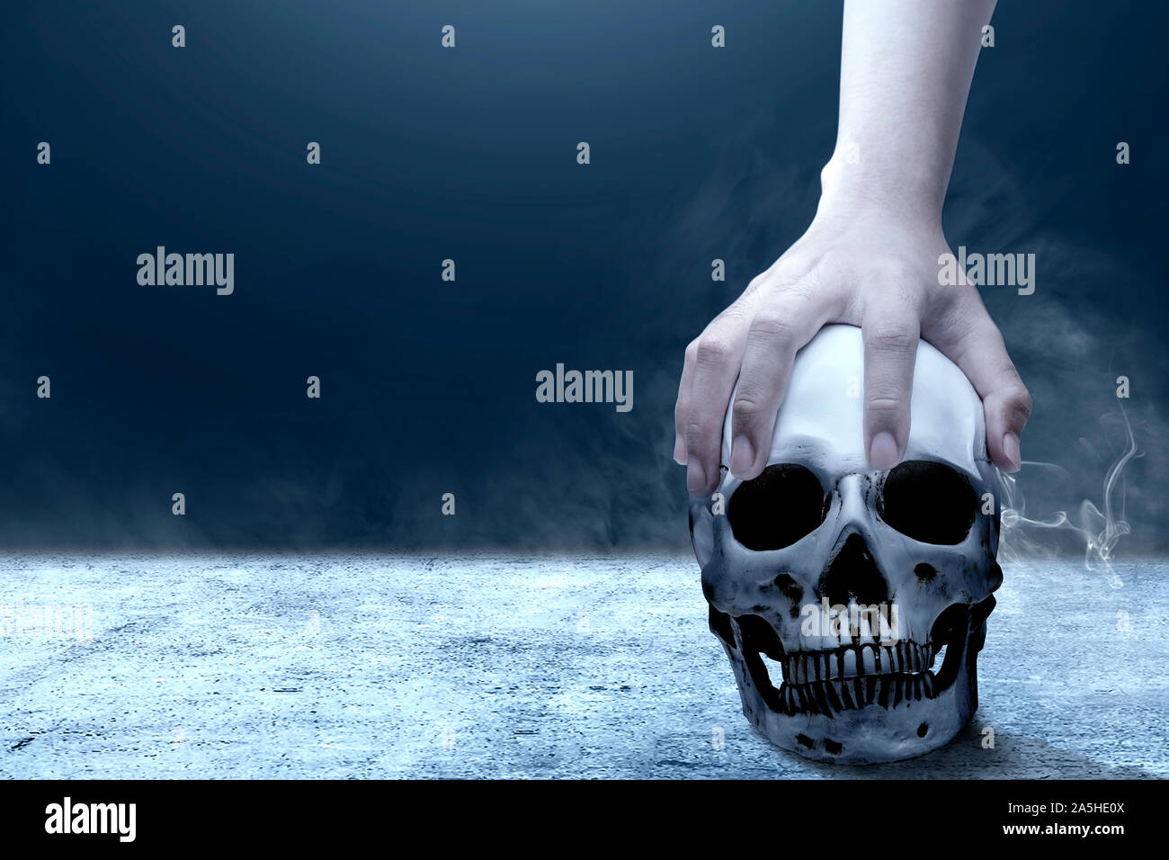 Dark human skull hand holding hi-res stock photography and images - Alamy