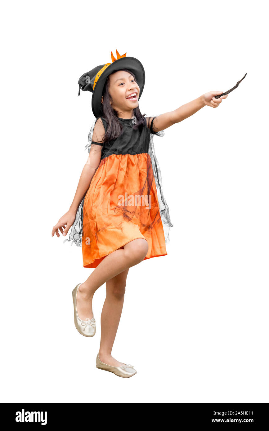 Asian girl in witch costume holding a magic wand isolated over white ...