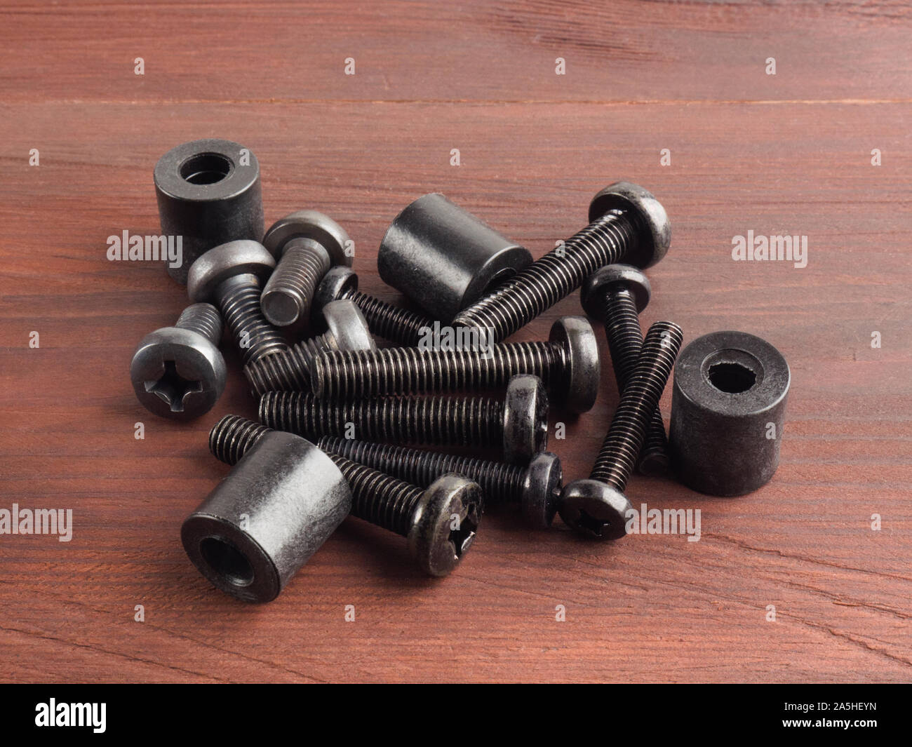 Set of screws and bushings on a brown background. Industrial theme ...