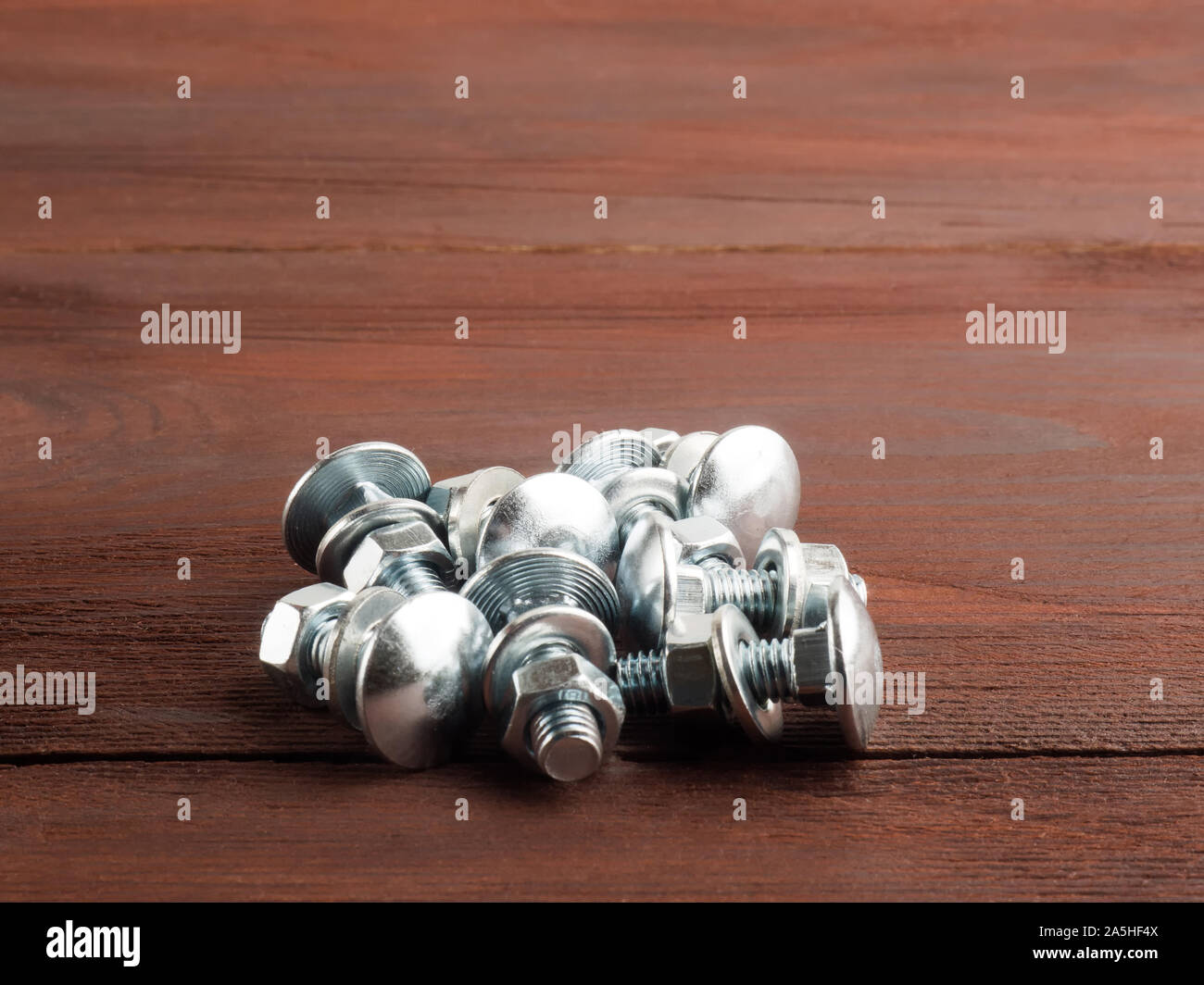 Set of screws, nuts and washers on a brown background. Industrial theme ...