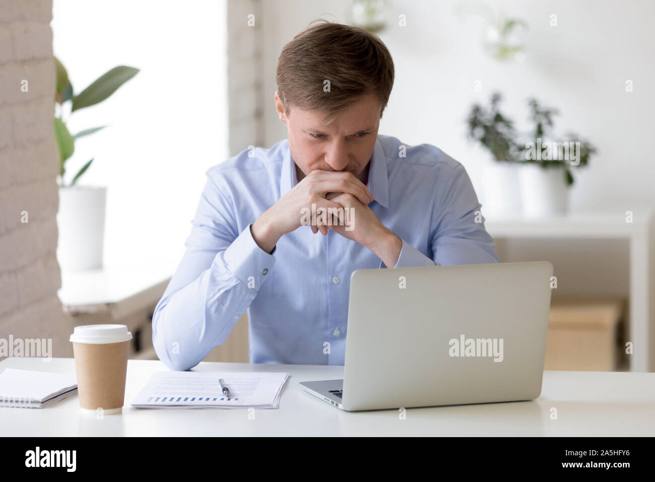 Serious man stuck with hard task, report calculations, problem solving ...