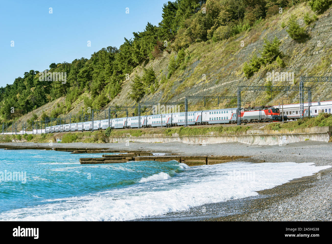 Passenger double deck train moves along Black sea coast. Sochi. Russia ...