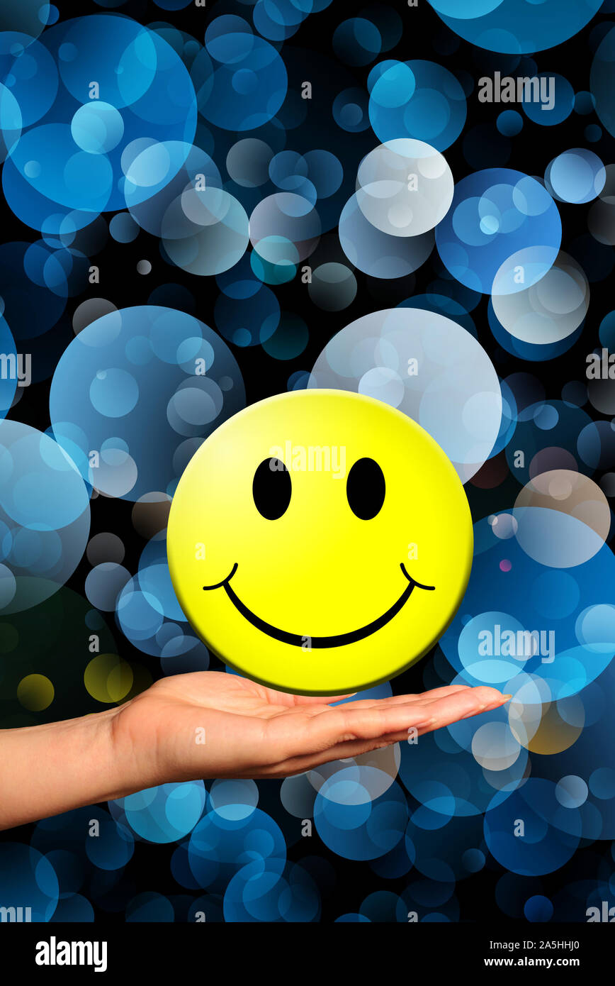 palm of hand holding a floating smiley - happiness concept Stock Photo ...
