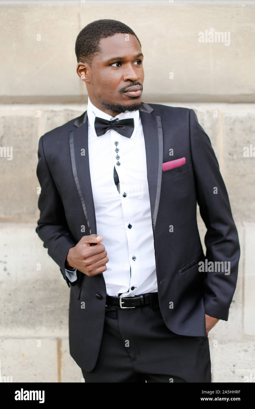 Afro american successful man wearing dark suit and standing near ...