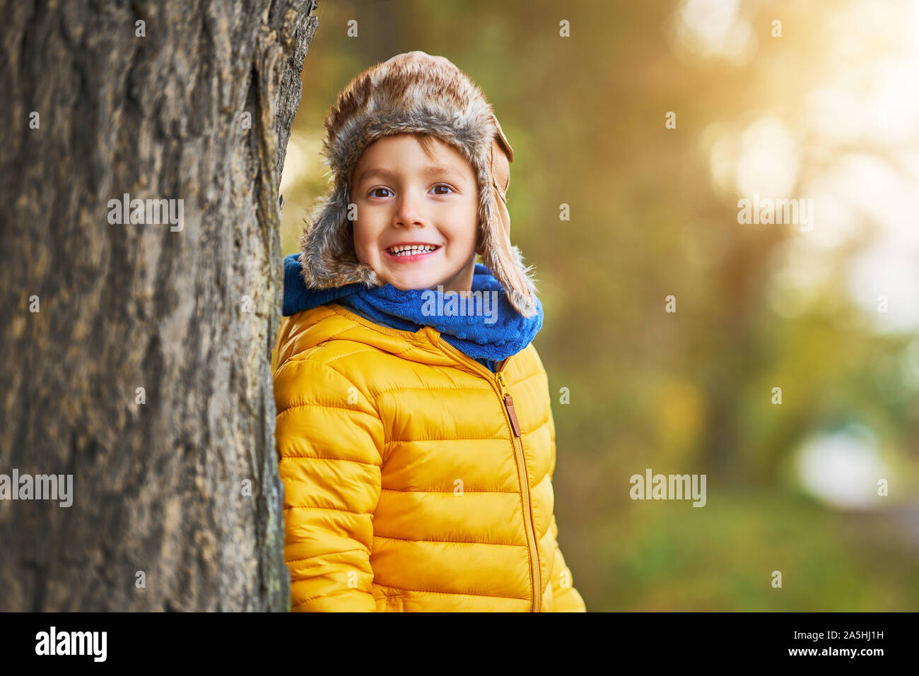 Happy child boy playing outside in autumn Stock Photo - Alamy