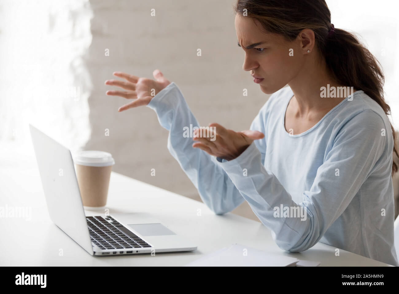 Stressed mixed race female employee irritated by bad computer work ...