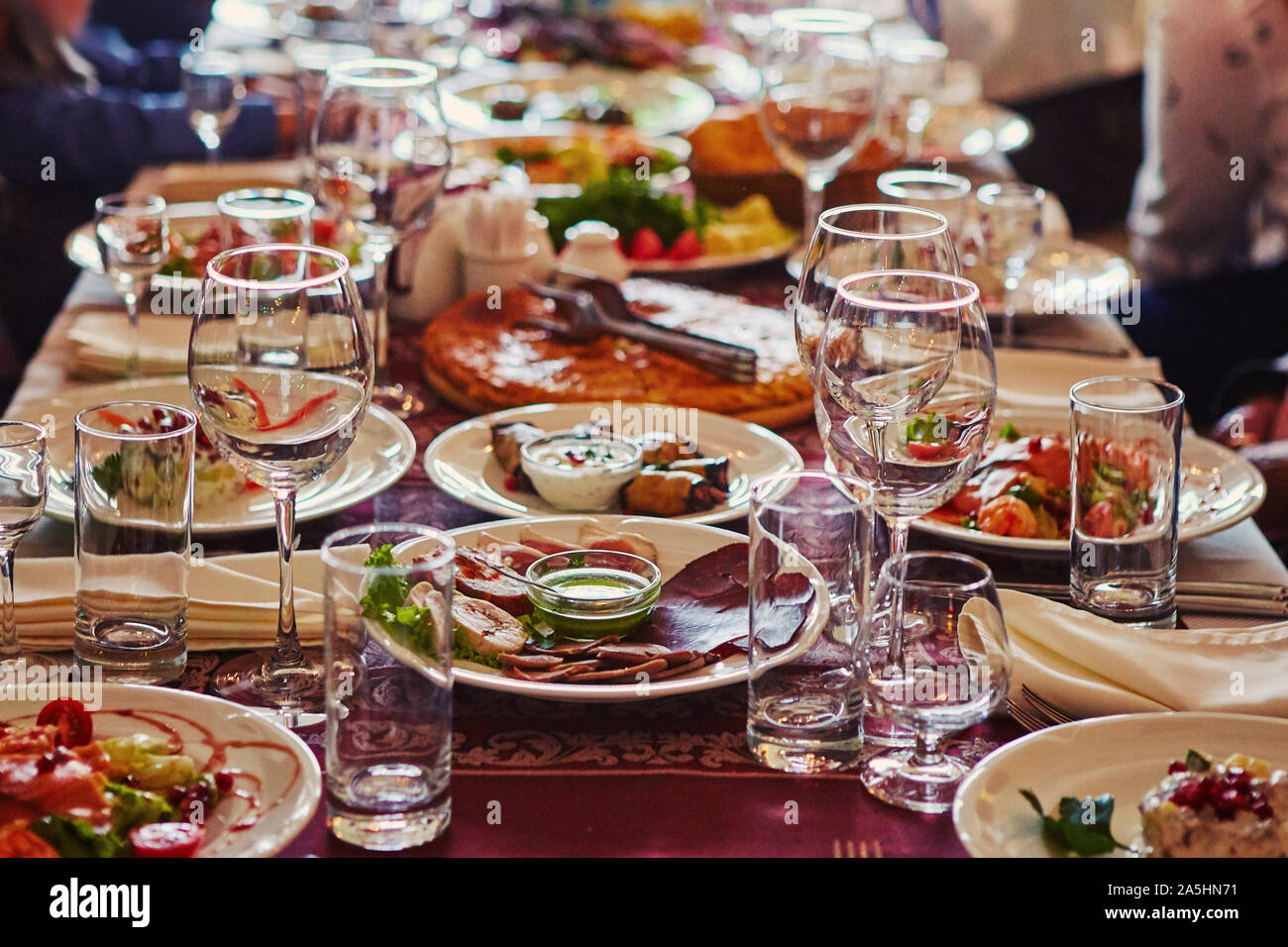 A group of people at a long table with food. The concept for the joint ...