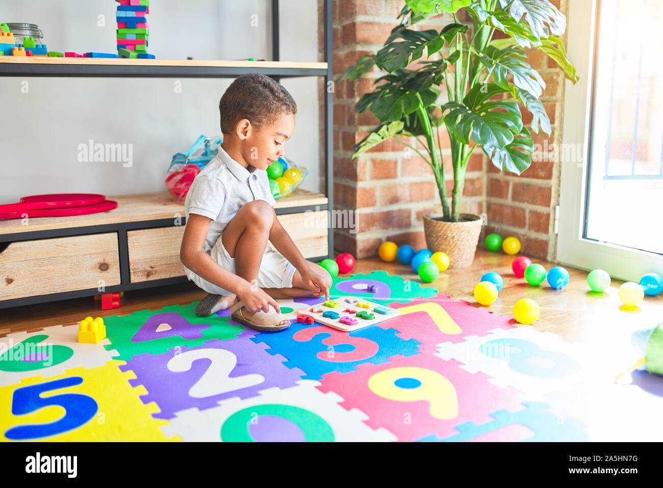 Beautiful african american toddler playing with maths game using ...
