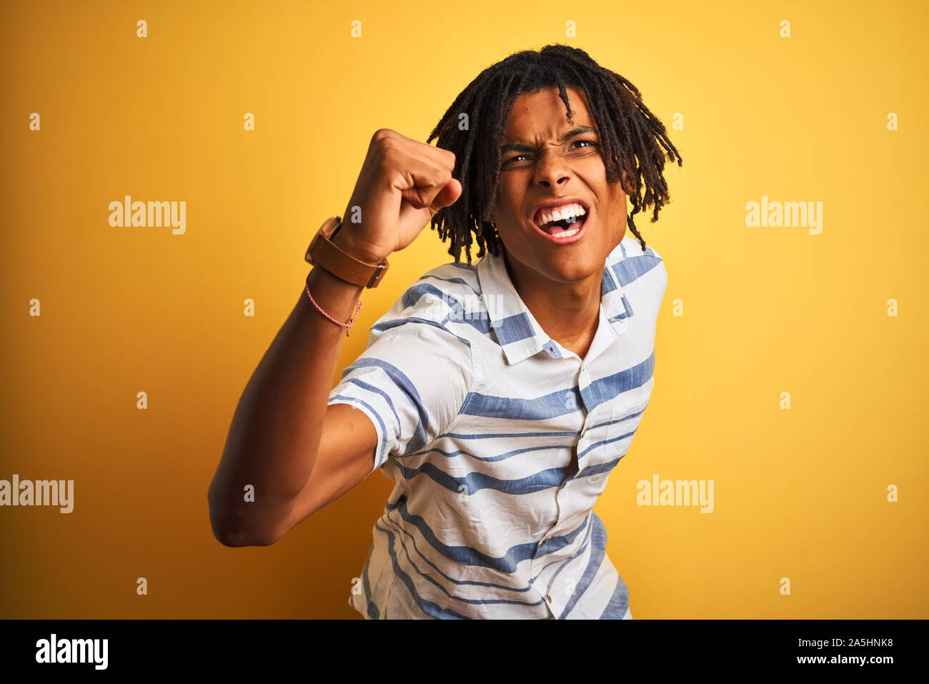 Afro american man with dreadlocks wearing striped shirt over isolated ...