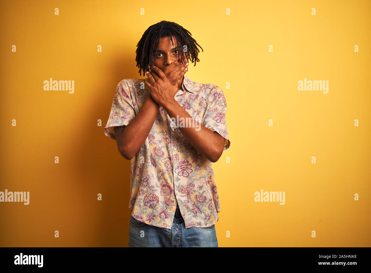 Afro man with dreadlocks on vacation wearing floral shirt over isolated ...