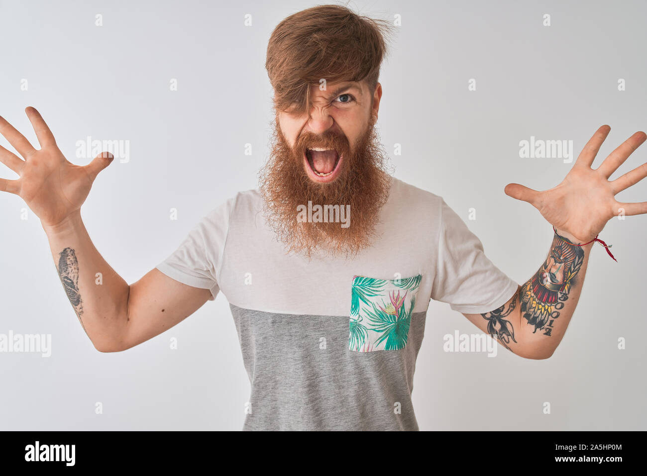 Young redhead irish man wearing t-shirt standing over isolated white ...