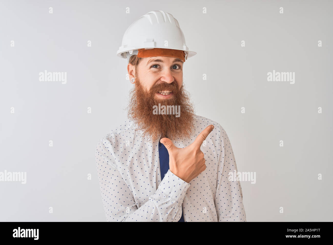 Young redhead irish architect man wearing security helmet over isolated ...