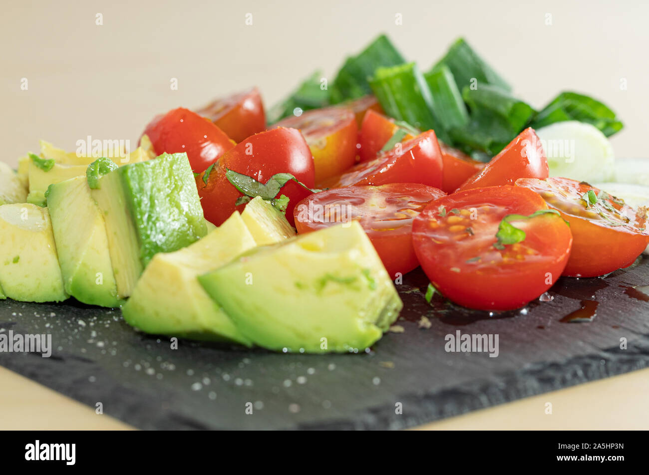 Salad - avocado, spring onion and tomato stock photo Stock Photo - Alamy