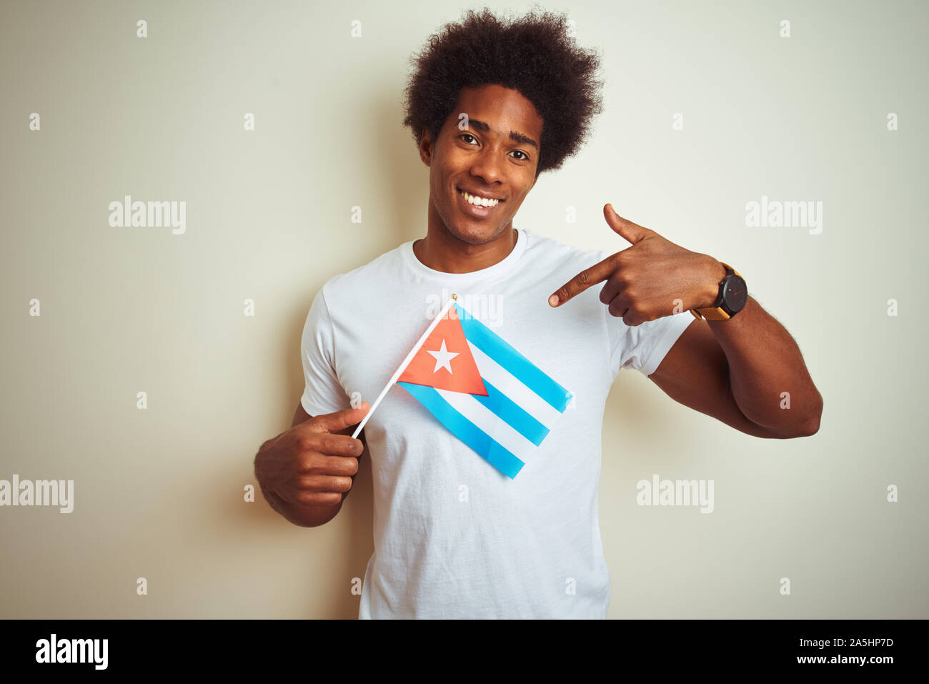 Young african american man holding Cuba Cuban flag standing over ...