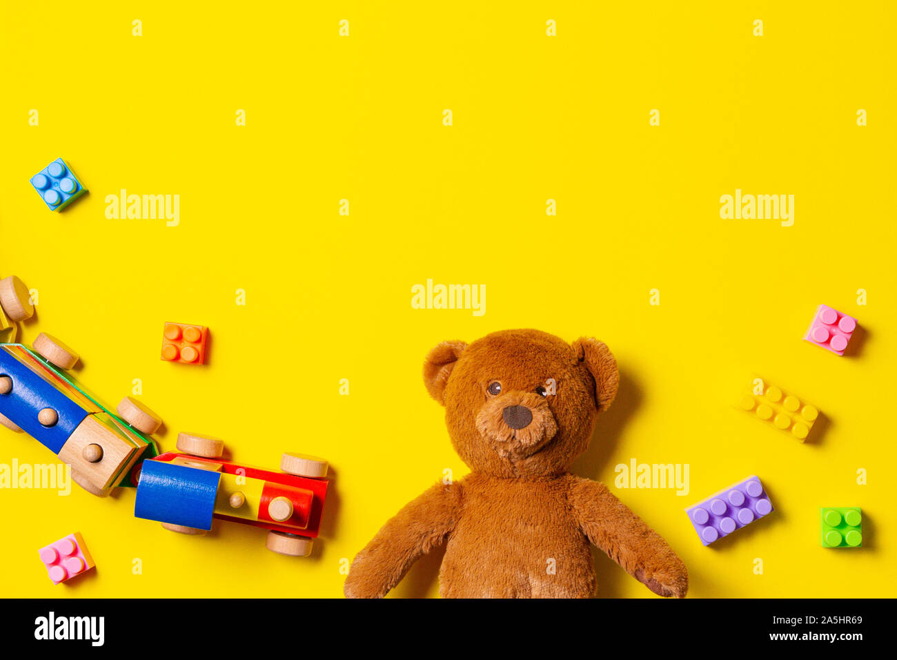 Baby kids toys background. Teddy bear, wooden train and colorful blocks ...