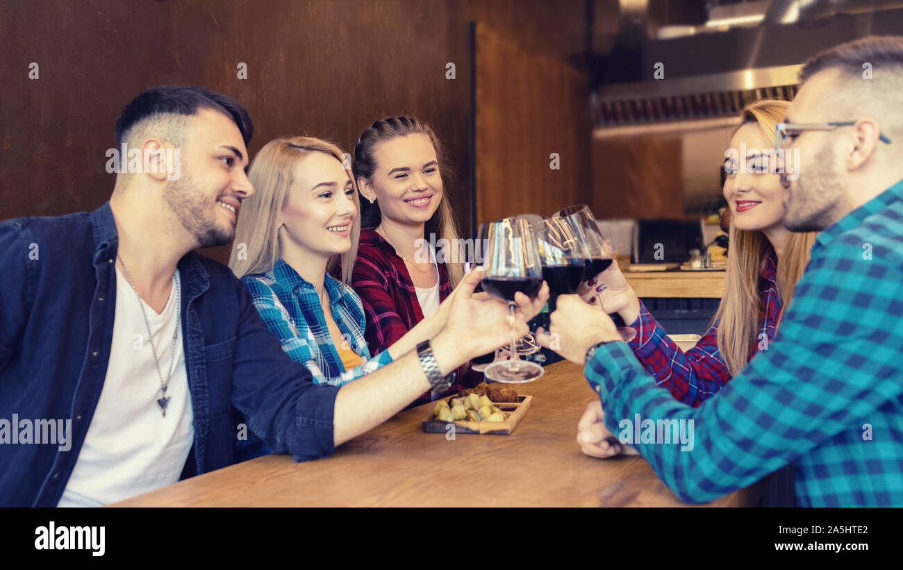 Young friends toasting wine hi-res stock photography and images - Alamy