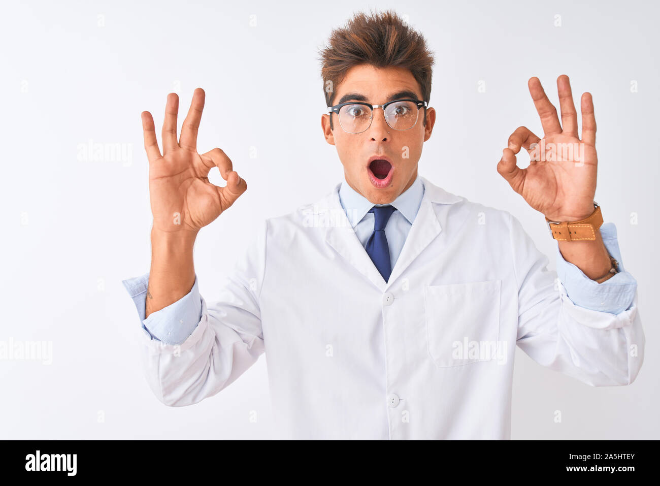 Young handsome sciencist man wearing glasses and coat over isolated ...