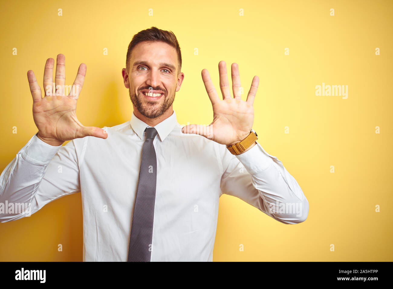 Young handsome business man wearing elegant white shirt over yellow ...