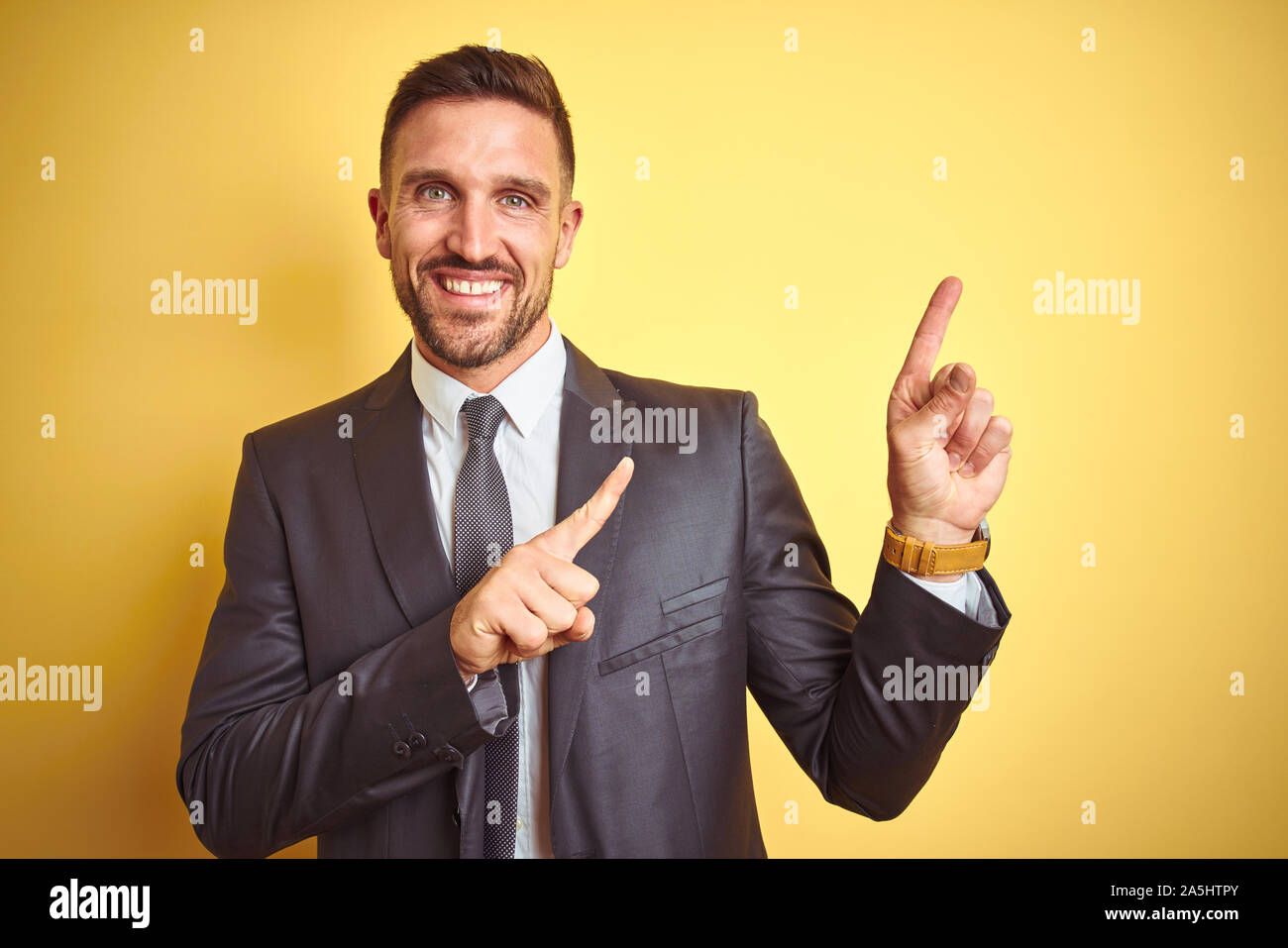 Young handsome business man over yellow isolated background smiling and ...