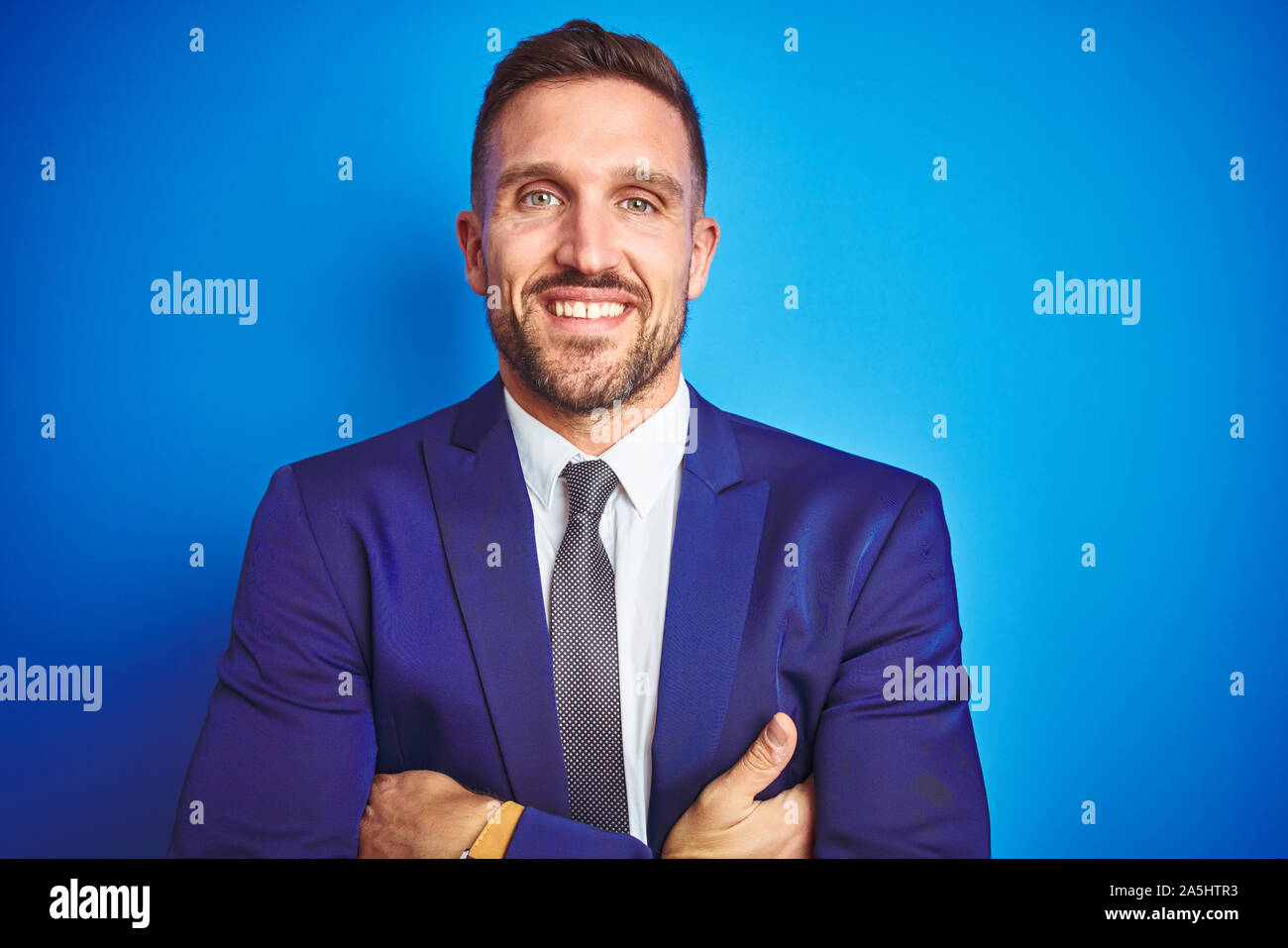 Close up picture of young handsome business man over blue isolated ...
