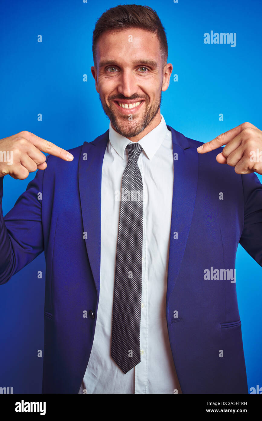 Vertical angle picture of young handsome business man over blue ...