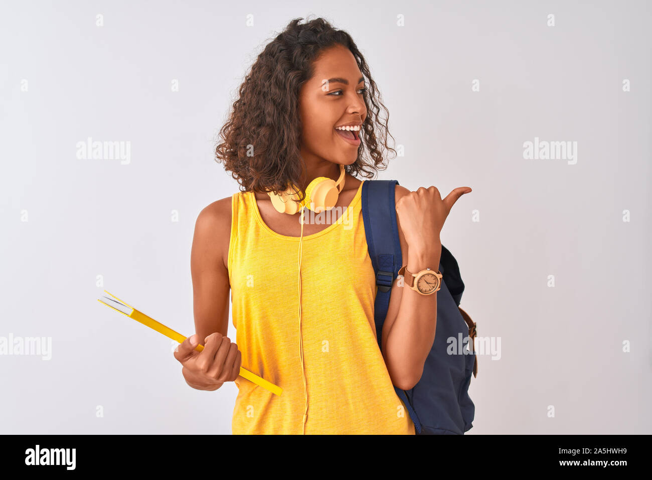 Brazilian student woman wearing backpack holding notebook over isolated ...