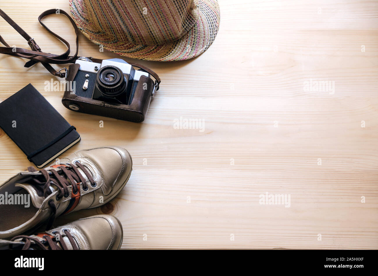 Travel concept. Essential vacation items, vintage camera, notepad, gold ...