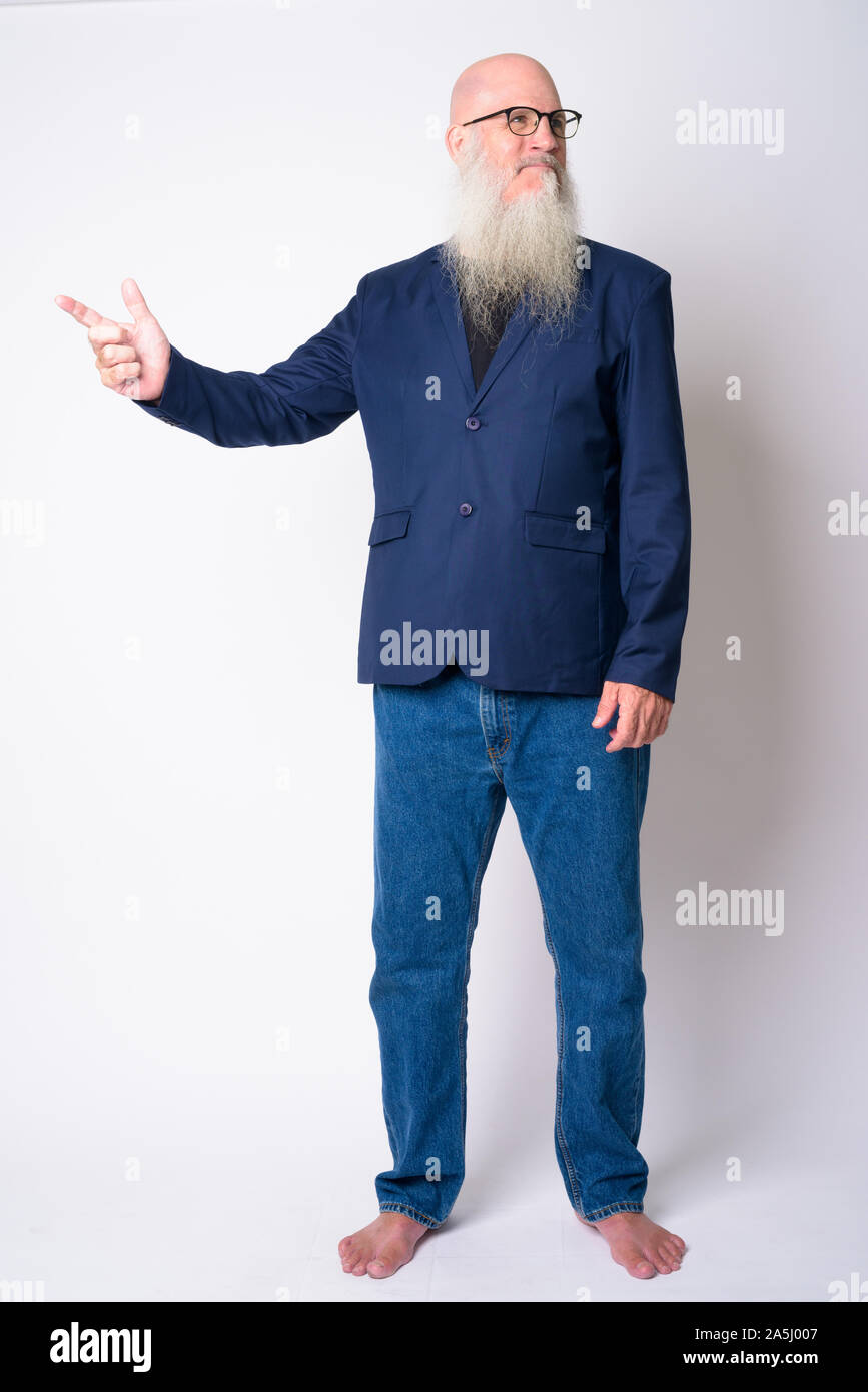 Full body shot of mature bearded bald businessman in suit showing ...