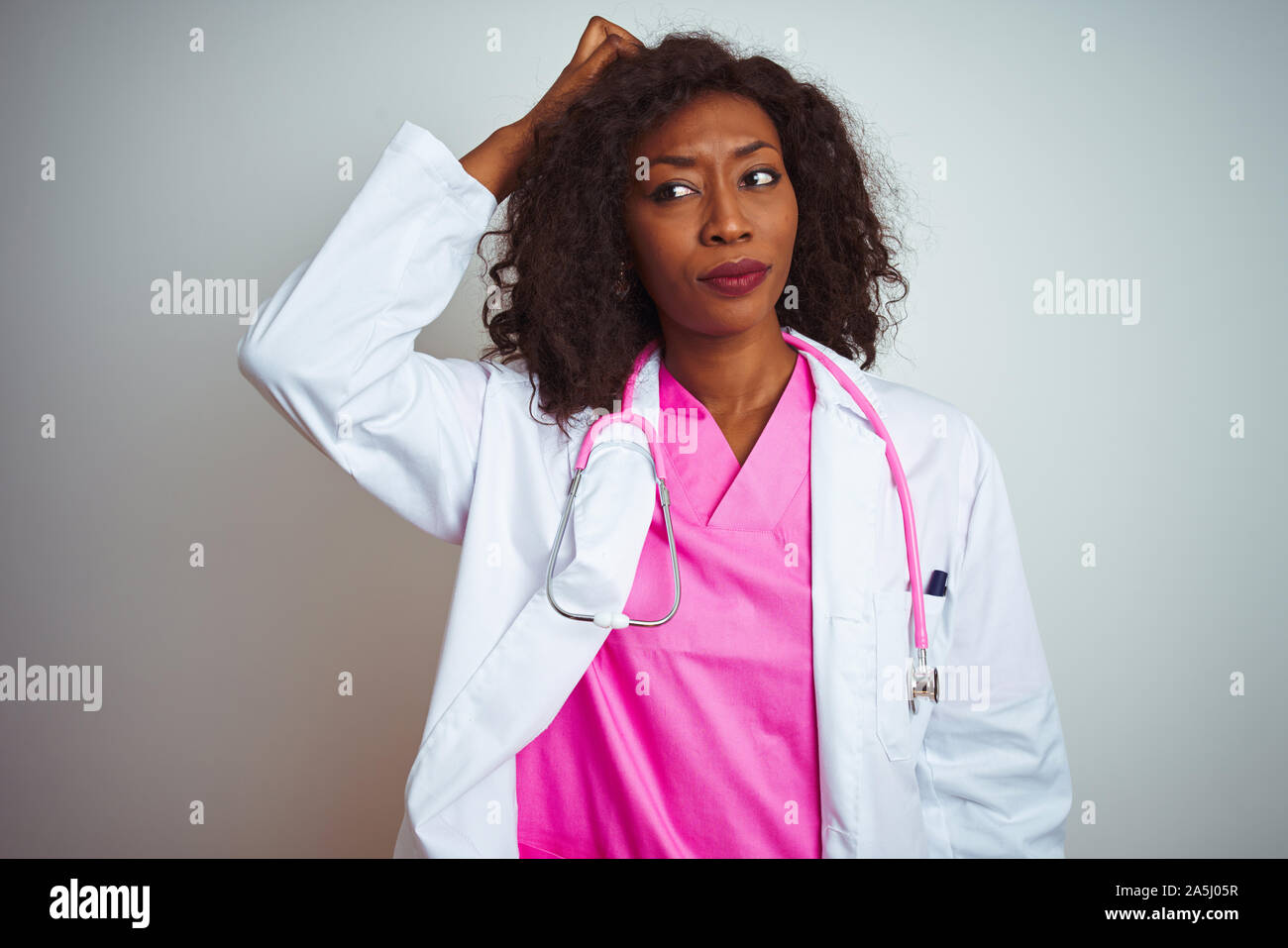 African american doctor woman wearing pink stethoscope over isolated ...