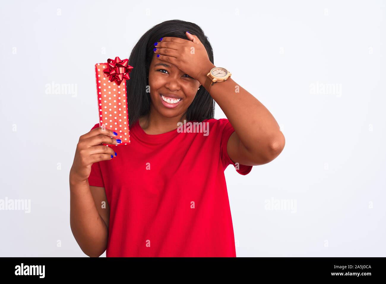 Young african american woman holding birthday present over isolated ...