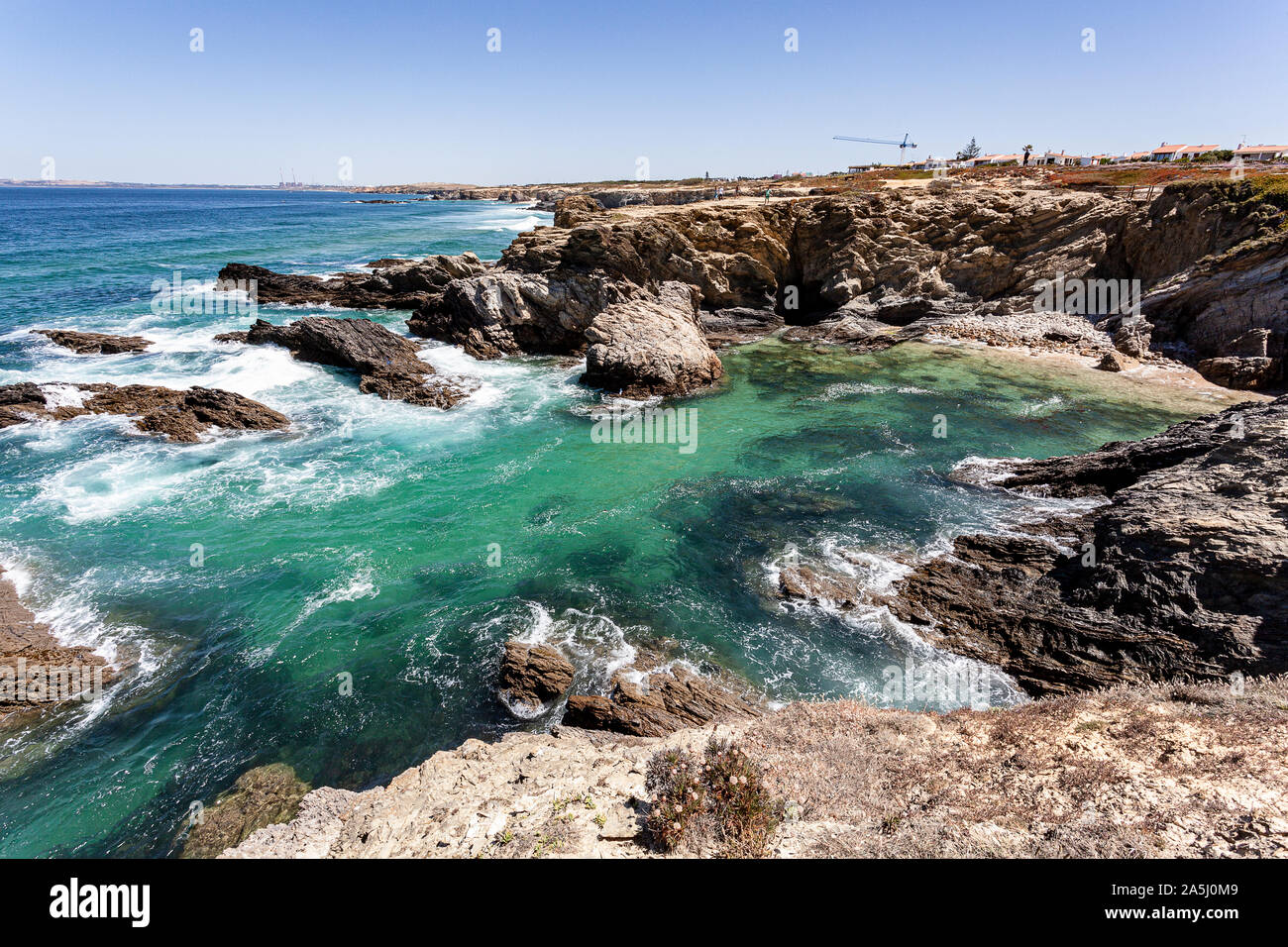 Transparent cove protected from sea waves by cliffs in Alentejo in ...