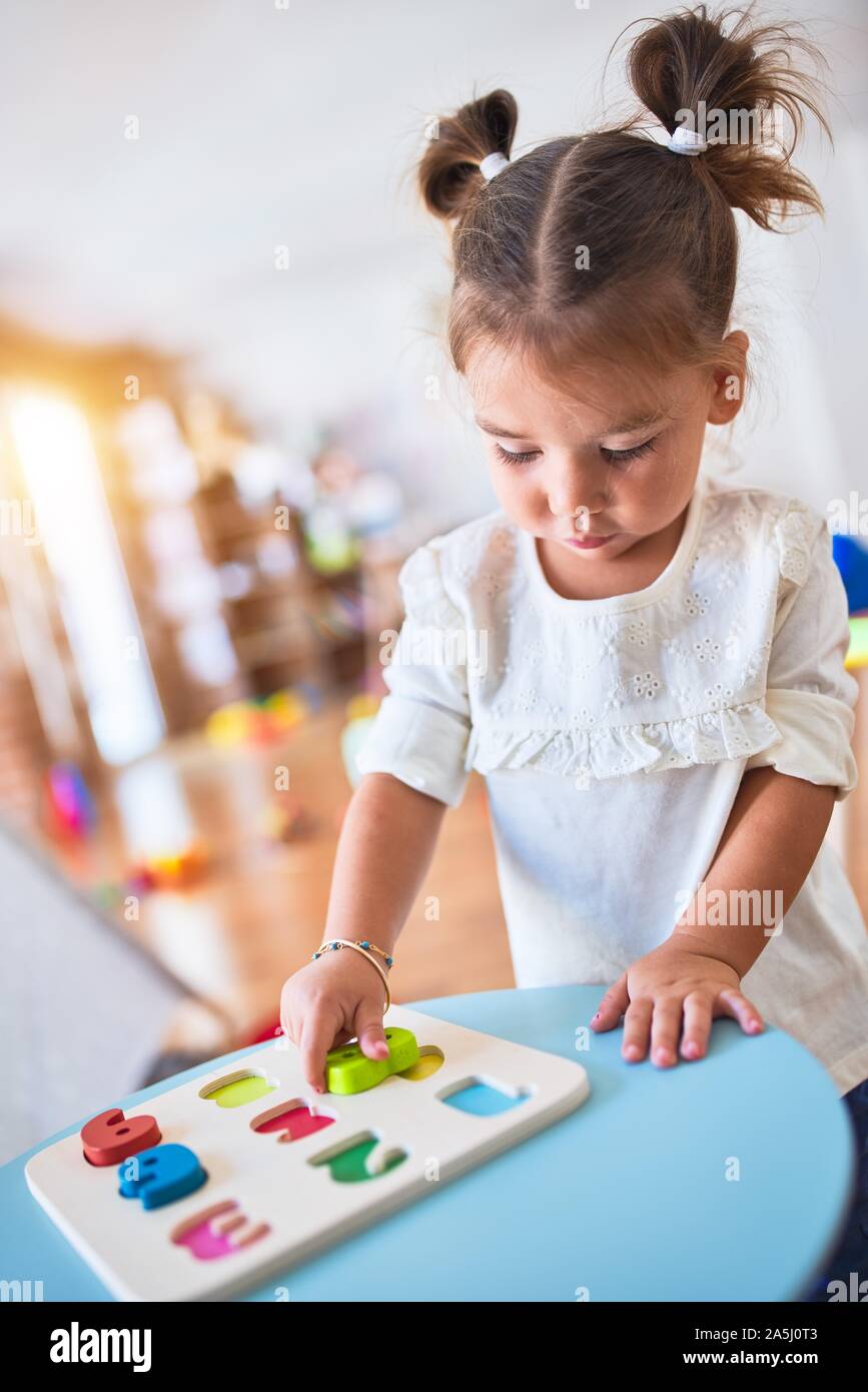 Young beautiful toddler learning mathematics playing with maths game at ...