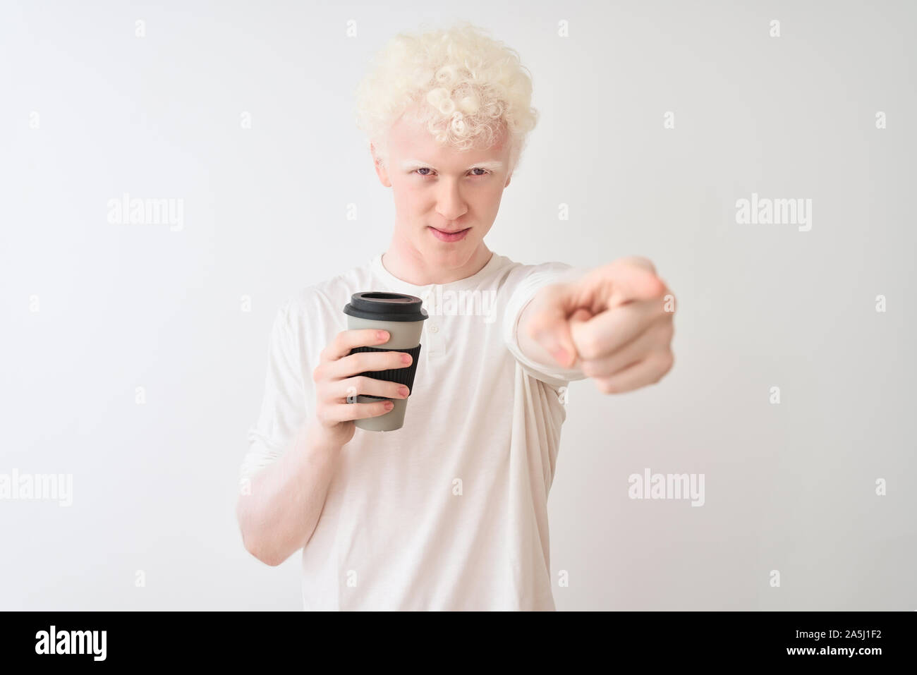 Young albino blond man drinking coffee standing over isolated white ...