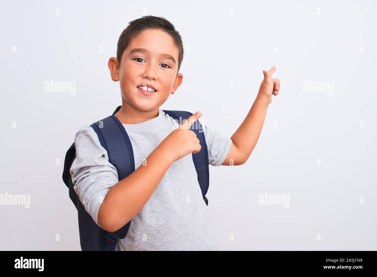 Beautiful student kid boy wearing backpack standing over isolated white ...