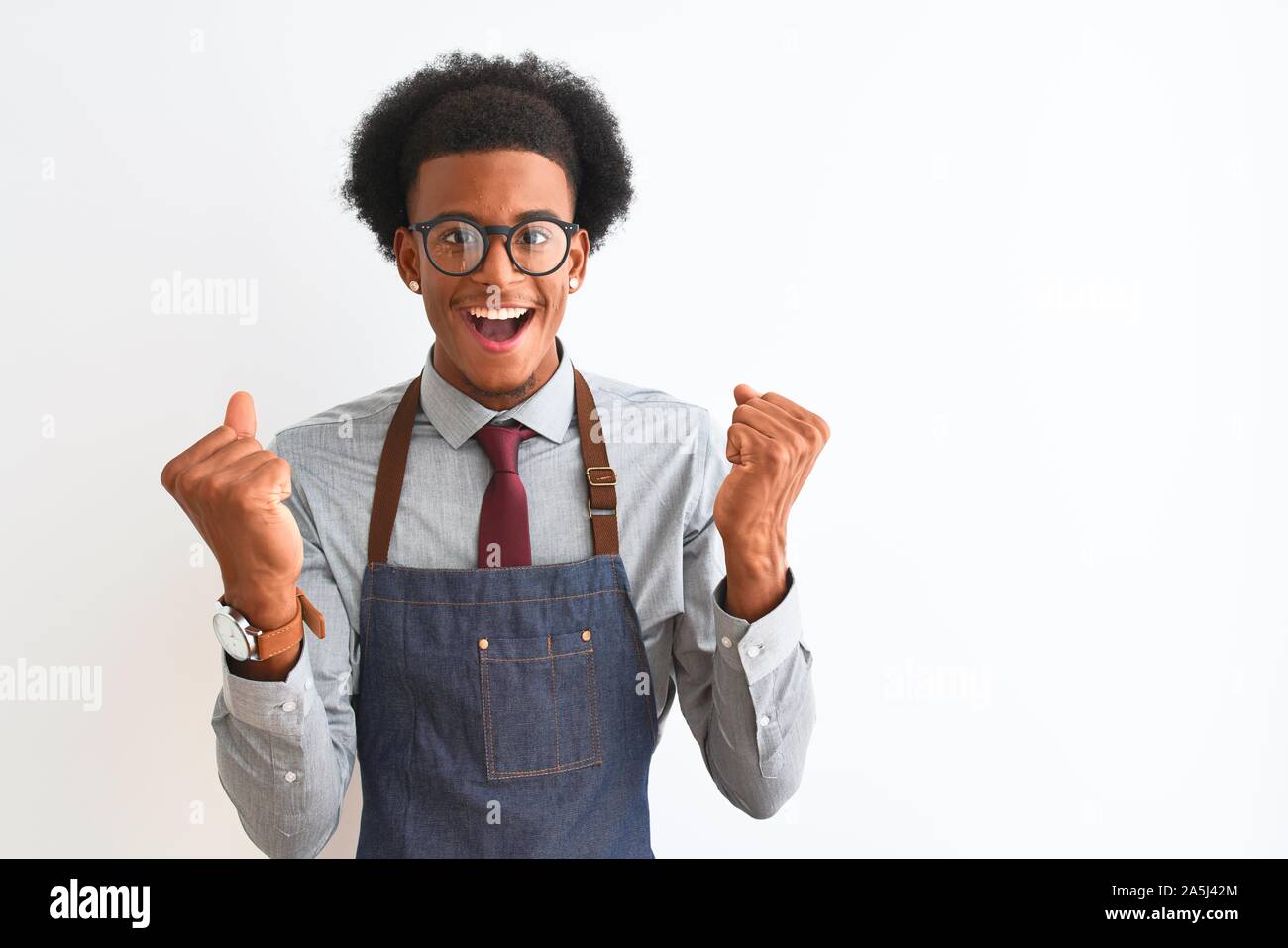 Young african american shopkeeper man wearing apron glasses over ...