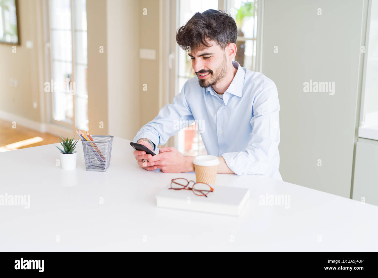 Young business man working using smartphone Stock Photo - Alamy