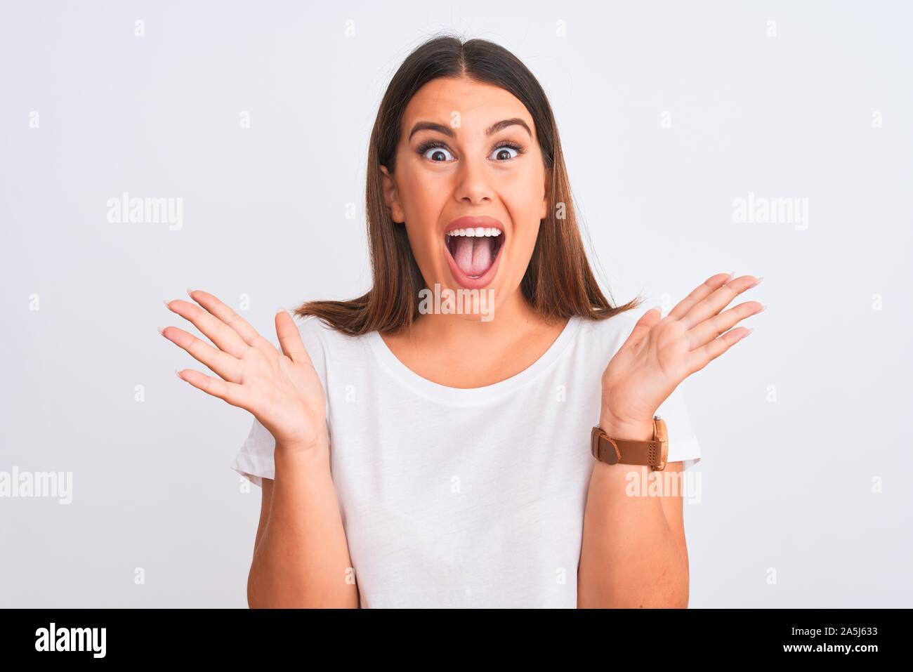 Portrait of beautiful and young brunette woman standing over isolated ...