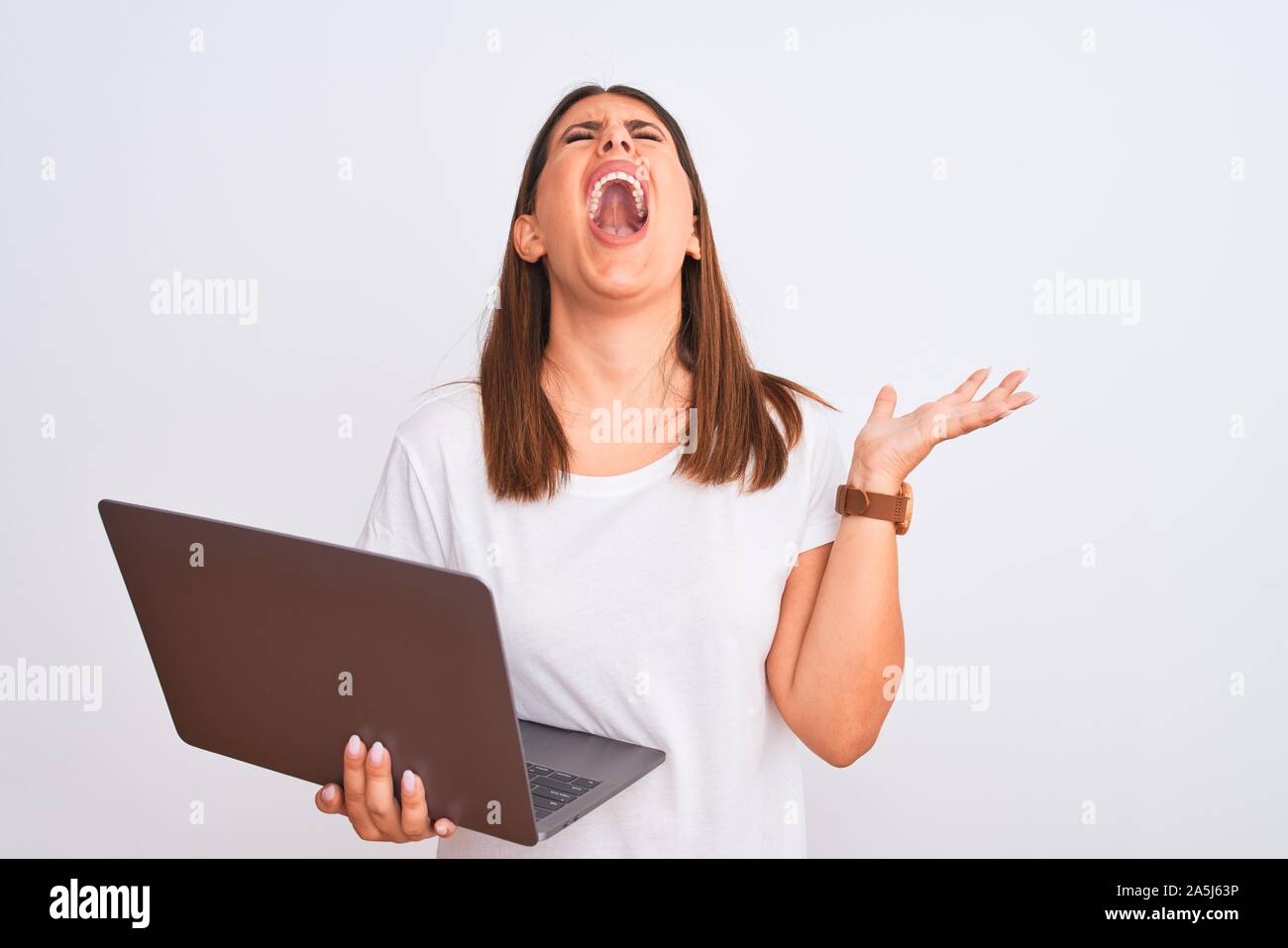 Beautiful young woman working using computer laptop over white ...