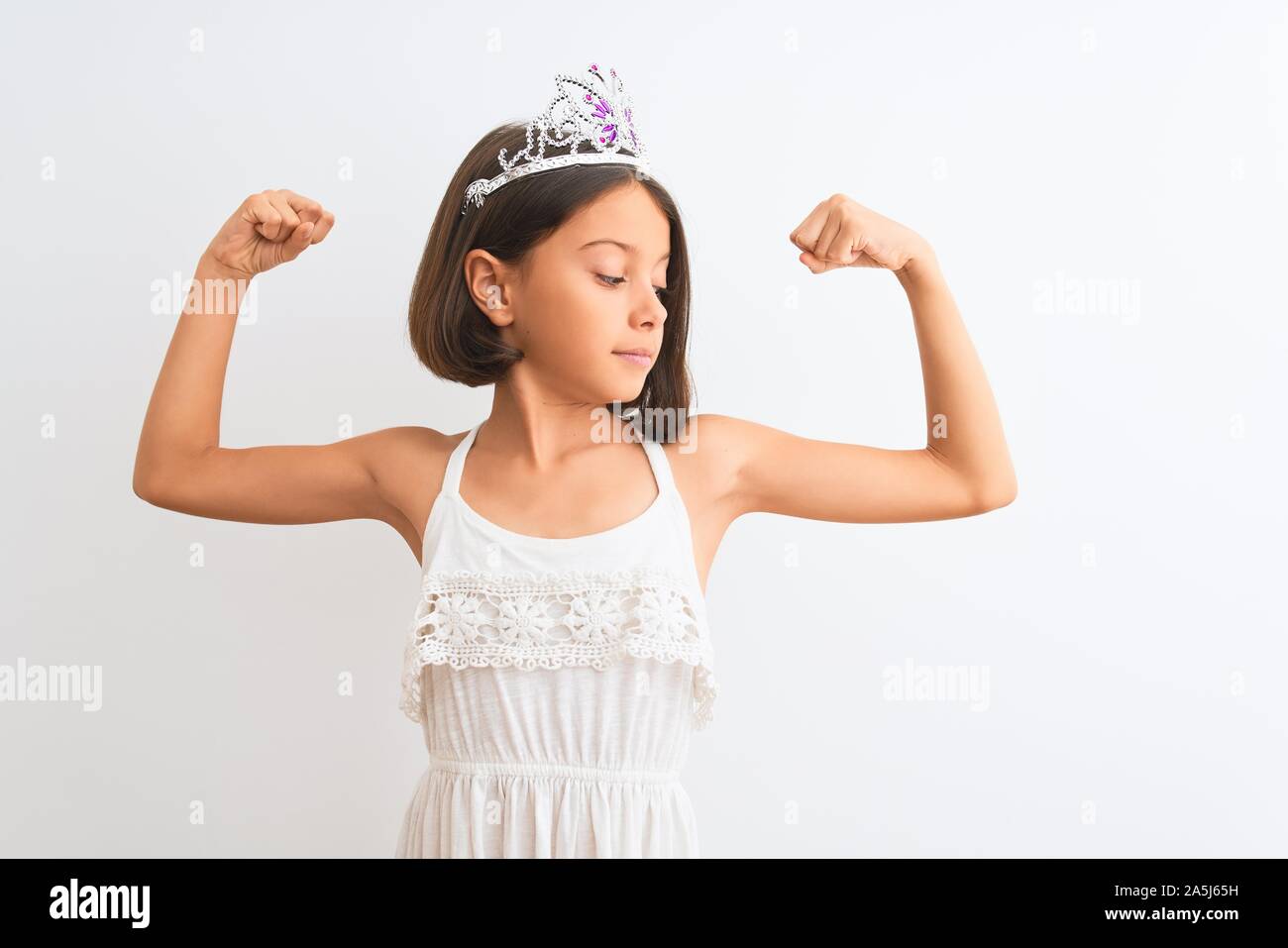 Beautiful child girl wearing princess crown standing over isolated ...
