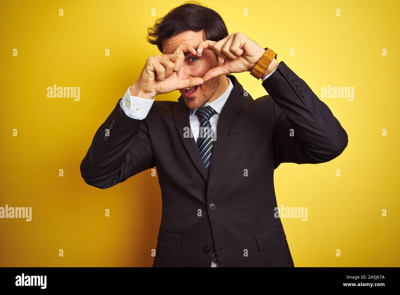 Young handsome businessman wearing suit and tie standing over isolated ...