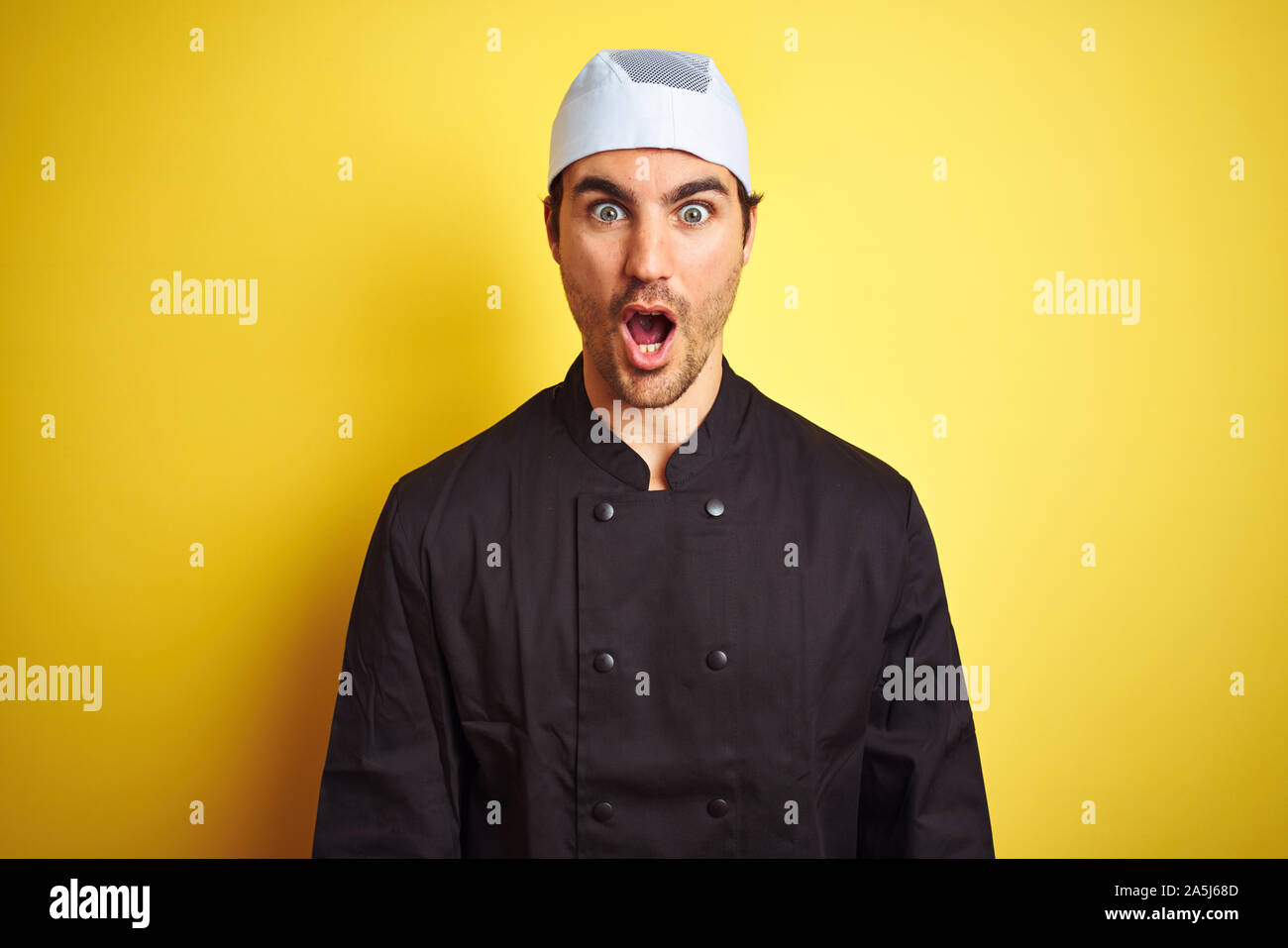 Young handsome chef man cooking wearing uniform and hat over isolated ...