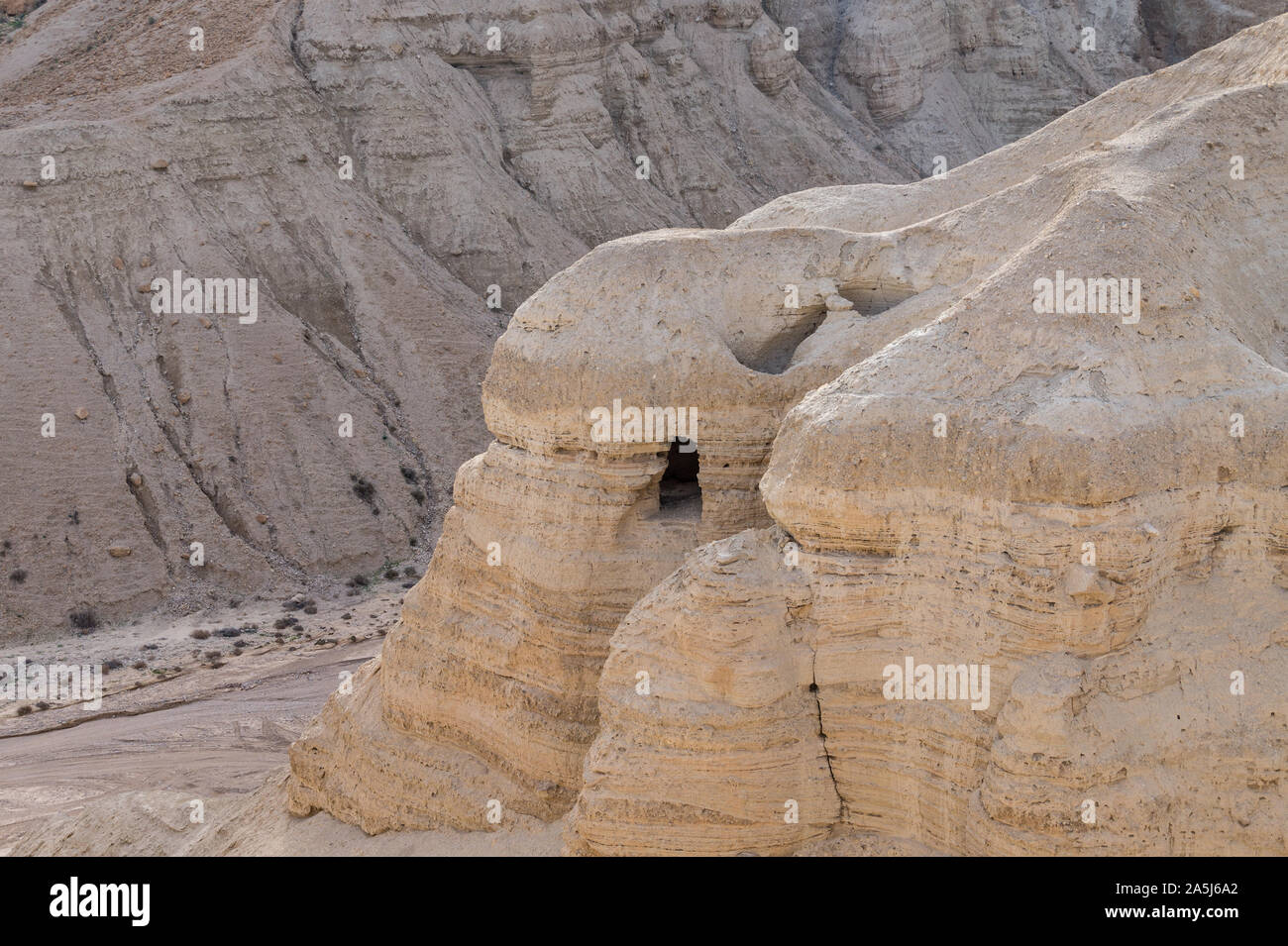 view of a cave in the Qumran National Park, an archaeological site in ...