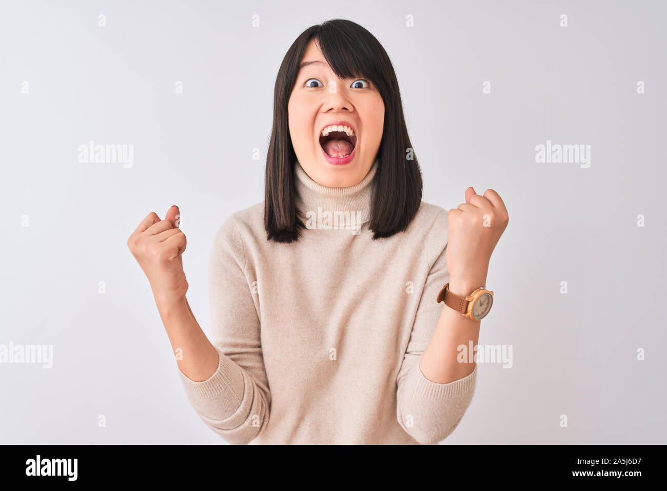 Young beautiful chinese woman wearing turtleneck sweater over isolated ...