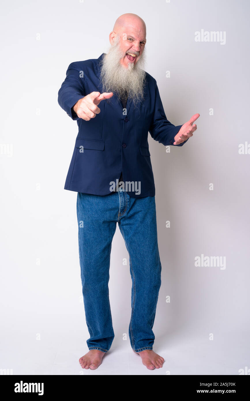 Full body shot of happy mature bearded bald businessman pointing at ...
