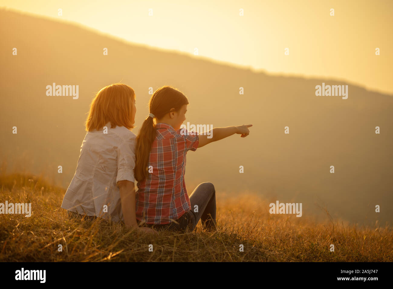 Happy grandmother and granddaughter enjoying nature and sunset Stock ...