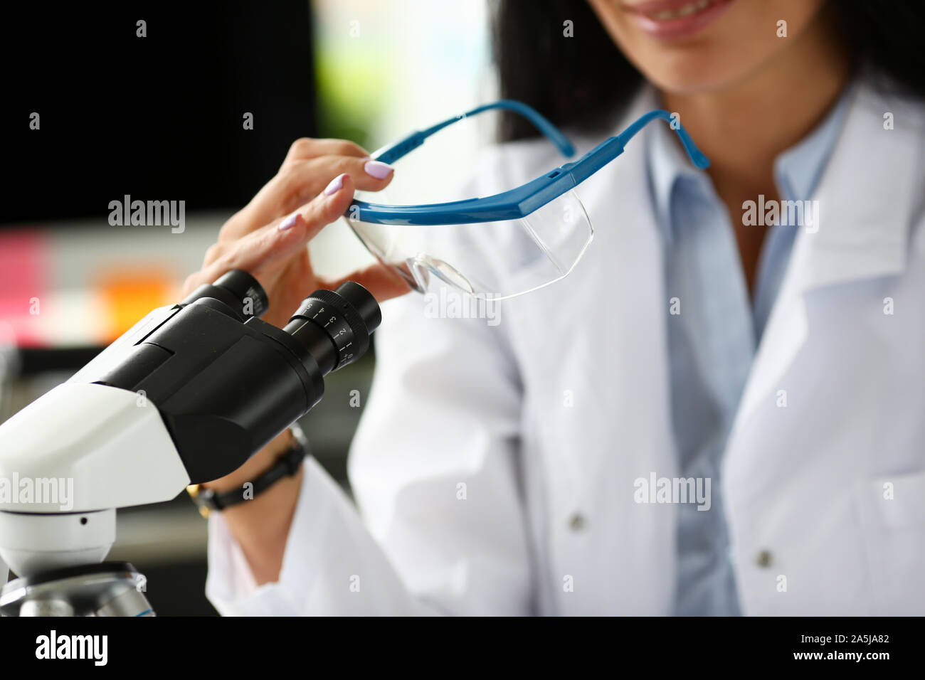 Researcher using microscope Stock Photo - Alamy